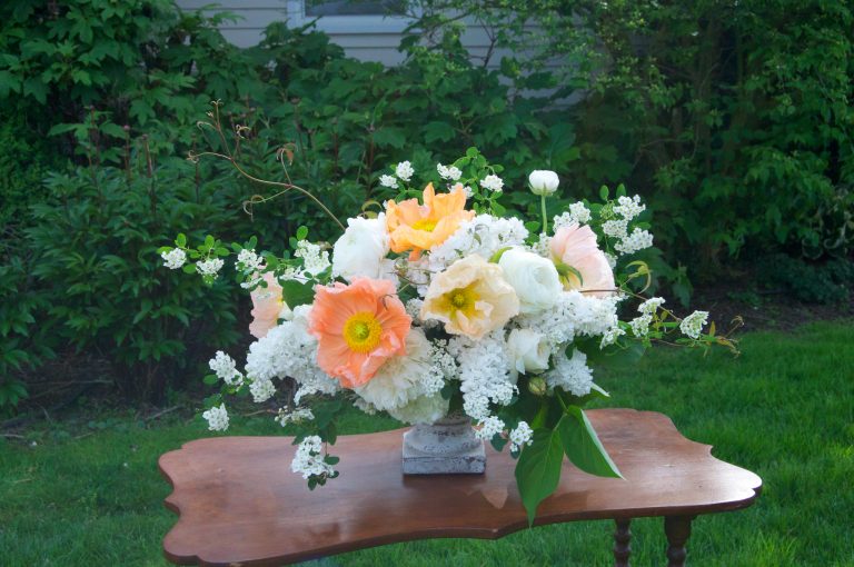 Peach and cream colored Spring flower centerpiece | Country Bouquets